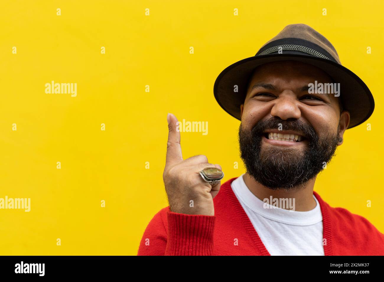 Adult Latino man (39) with beard, makes a gesture of success. He wears ...