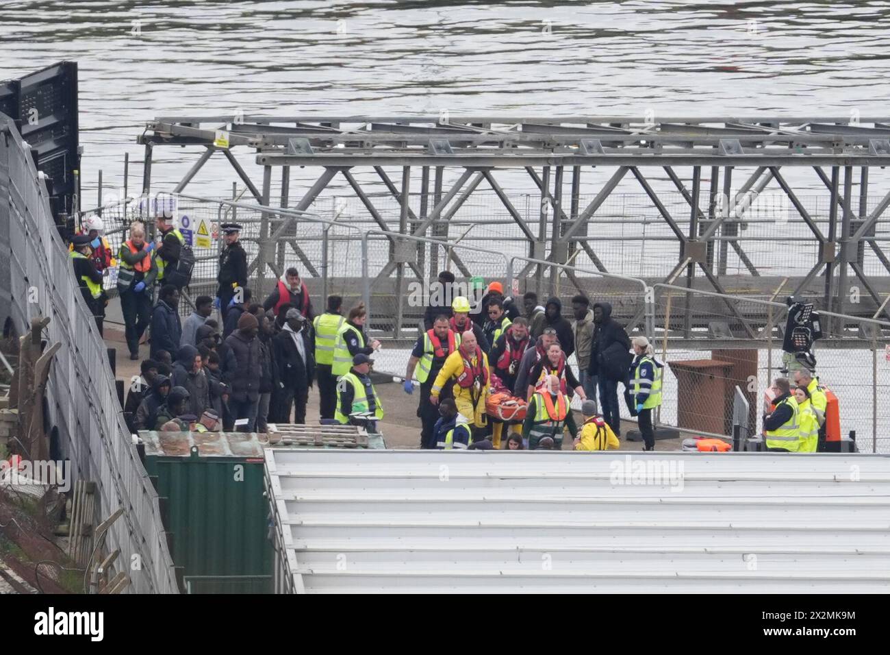 An RNLI crew carry a person in a stretcher towards an ambulance in to ...