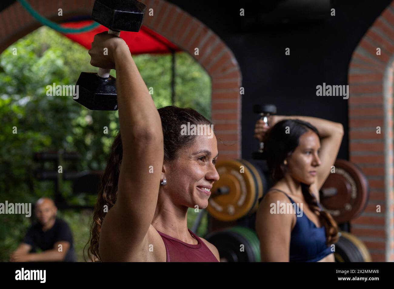 Two Latin American women perform high-intensity functional workouts at ...