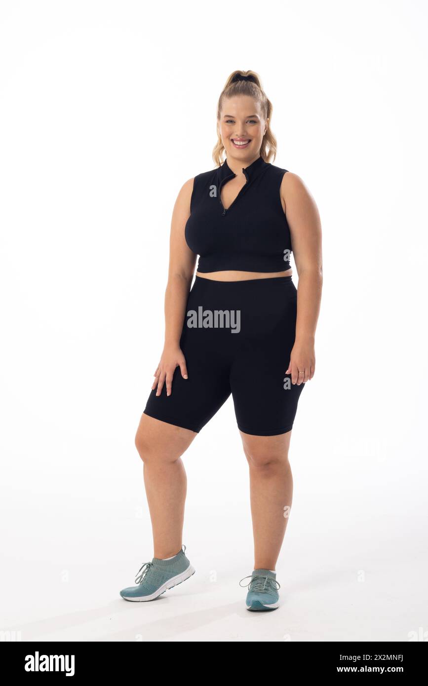 Caucasian plus size female model with hands on hips on white background ...