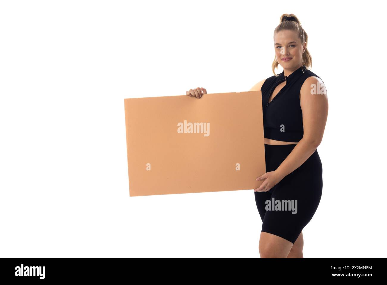 Plus size Caucasian woman in black dress holds blank sign on white ...