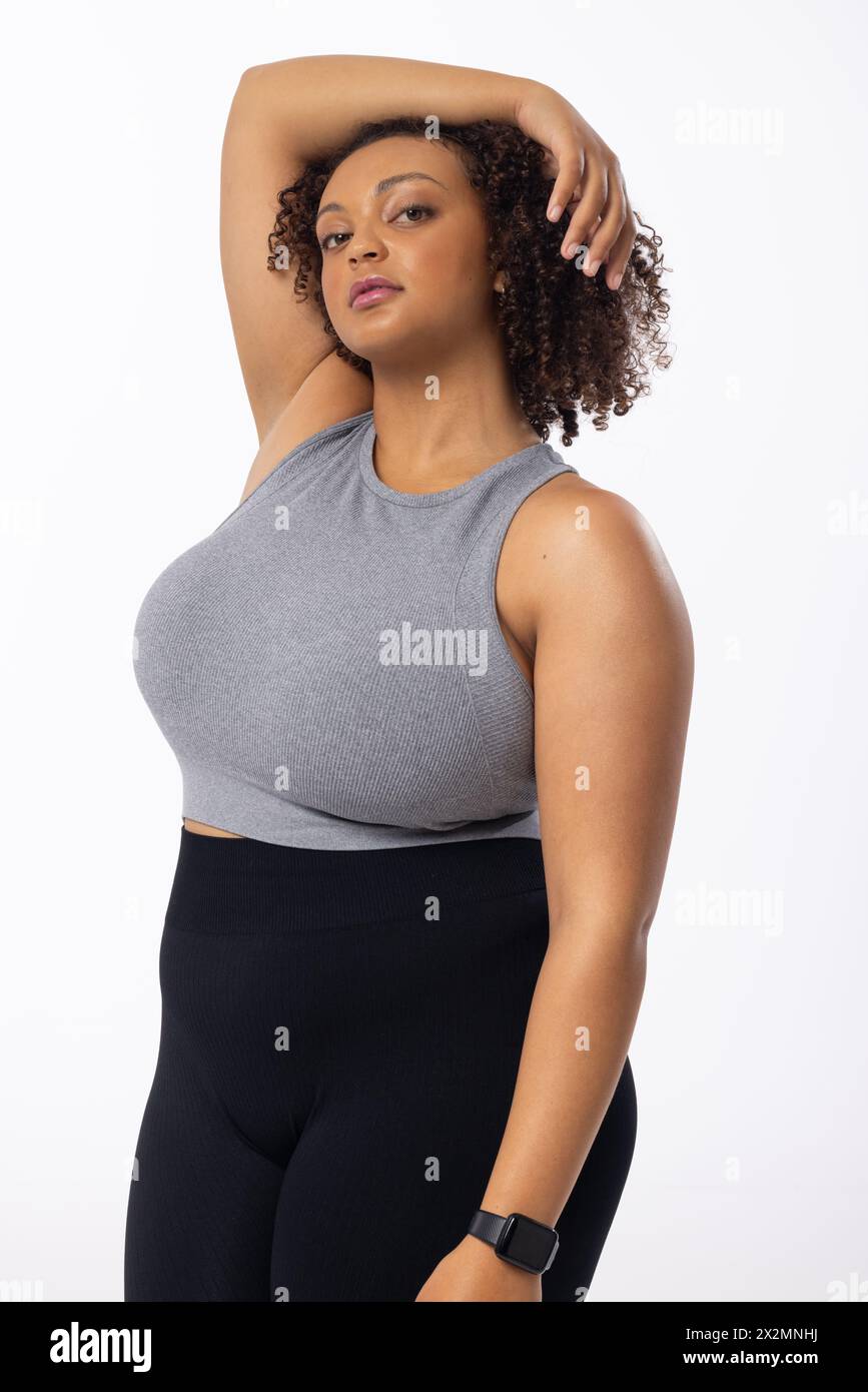 A biracial young female plus size model poses on white background Stock ...
