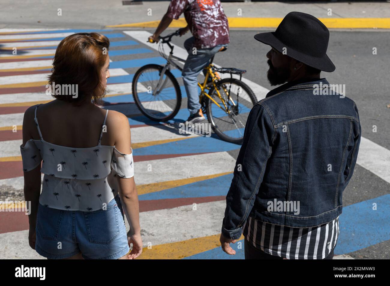 Man with beard and hat next to young Latin American woman both with ...