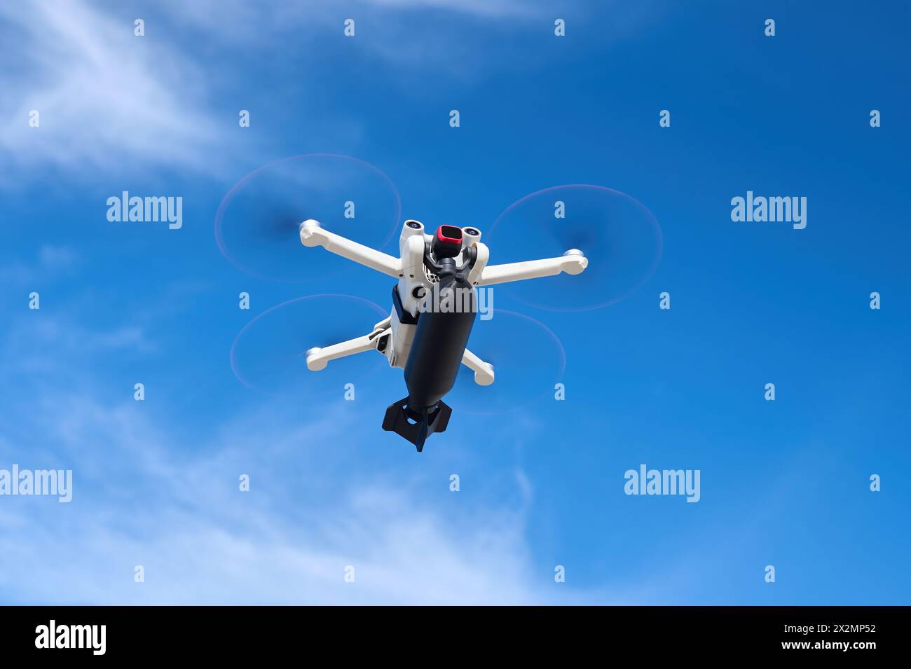 A civilian drone with a small bomb on board is flying in the sky Stock ...