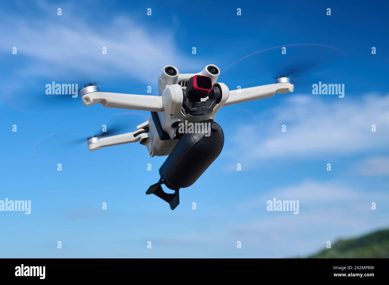 A civilian drone with a small bomb on board is flying in the sky Stock ...