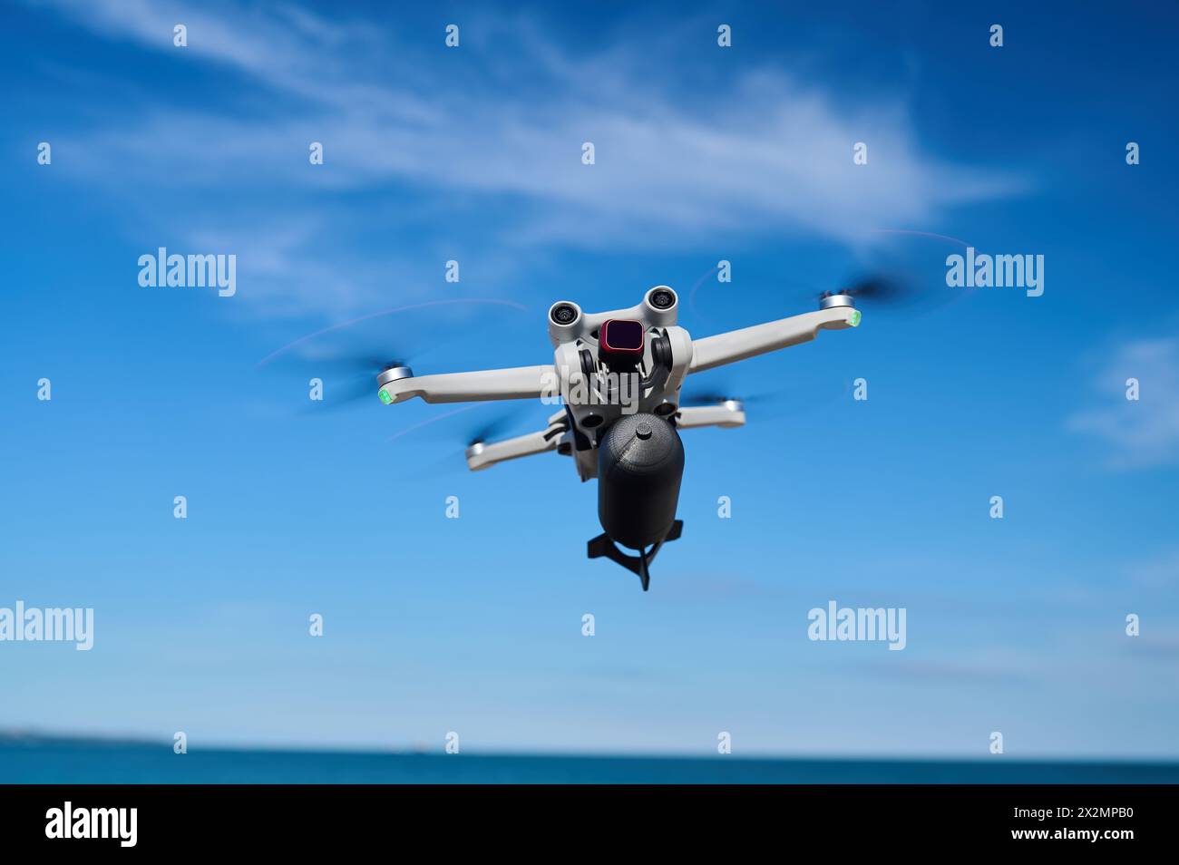 A civilian drone with a small bomb on board is flying in the sky Stock ...