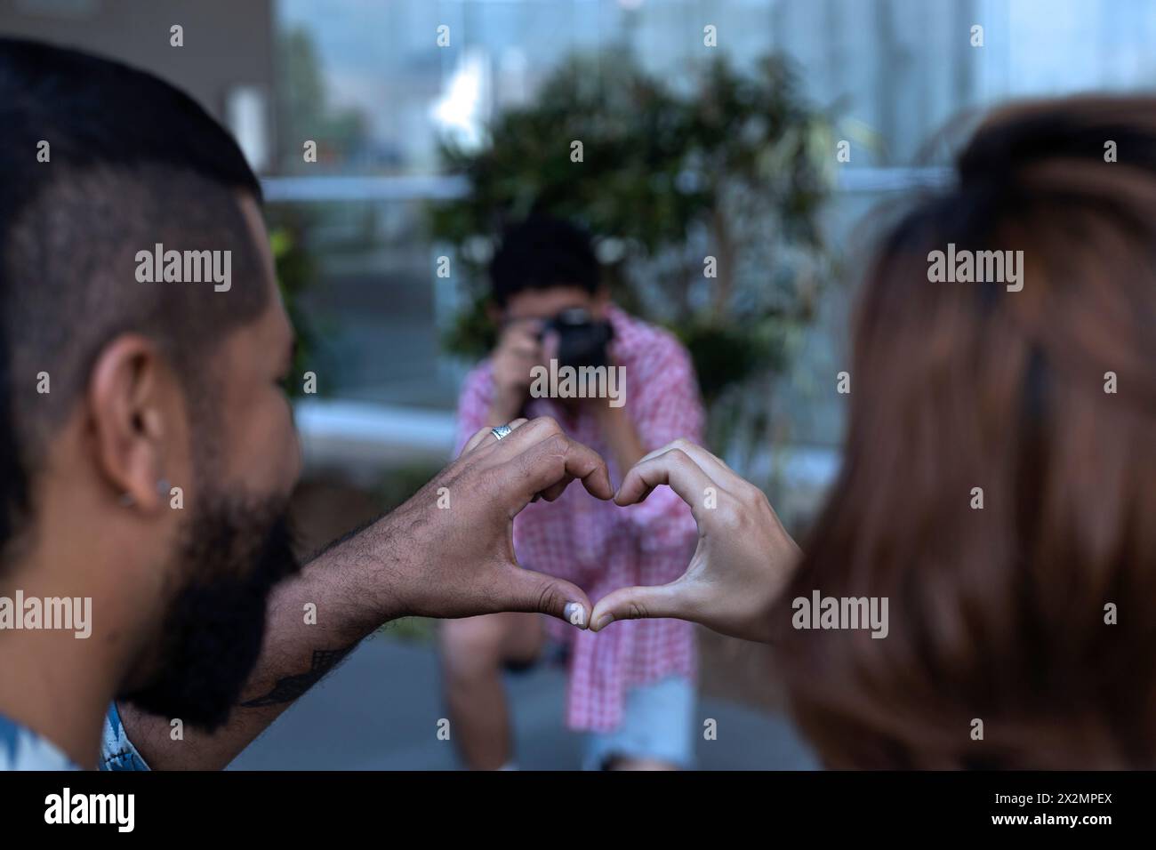 Young Latin American man on vacation takes pictures of his friends ...
