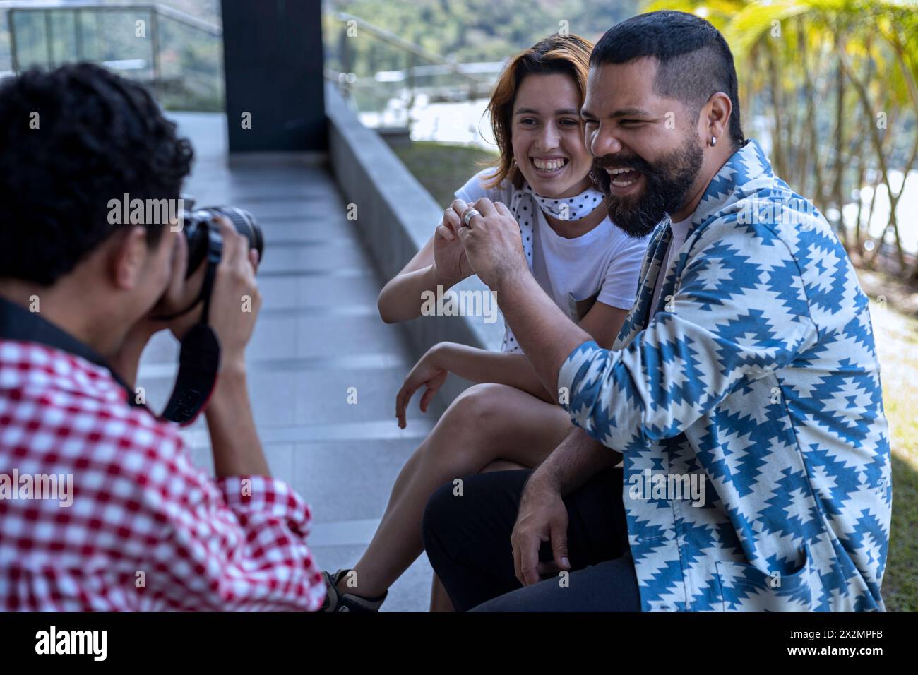Three Latin American friends on vacation taking pictures while having a ...