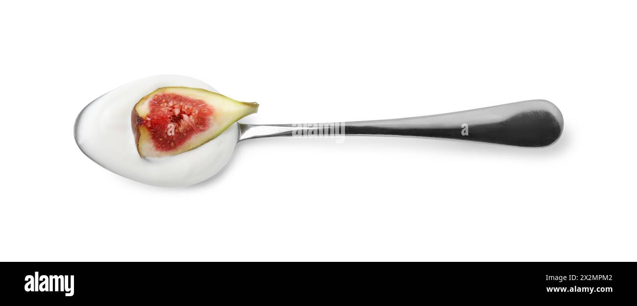 Spoon with yogurt and fig isolated on white Stock Photo - Alamy
