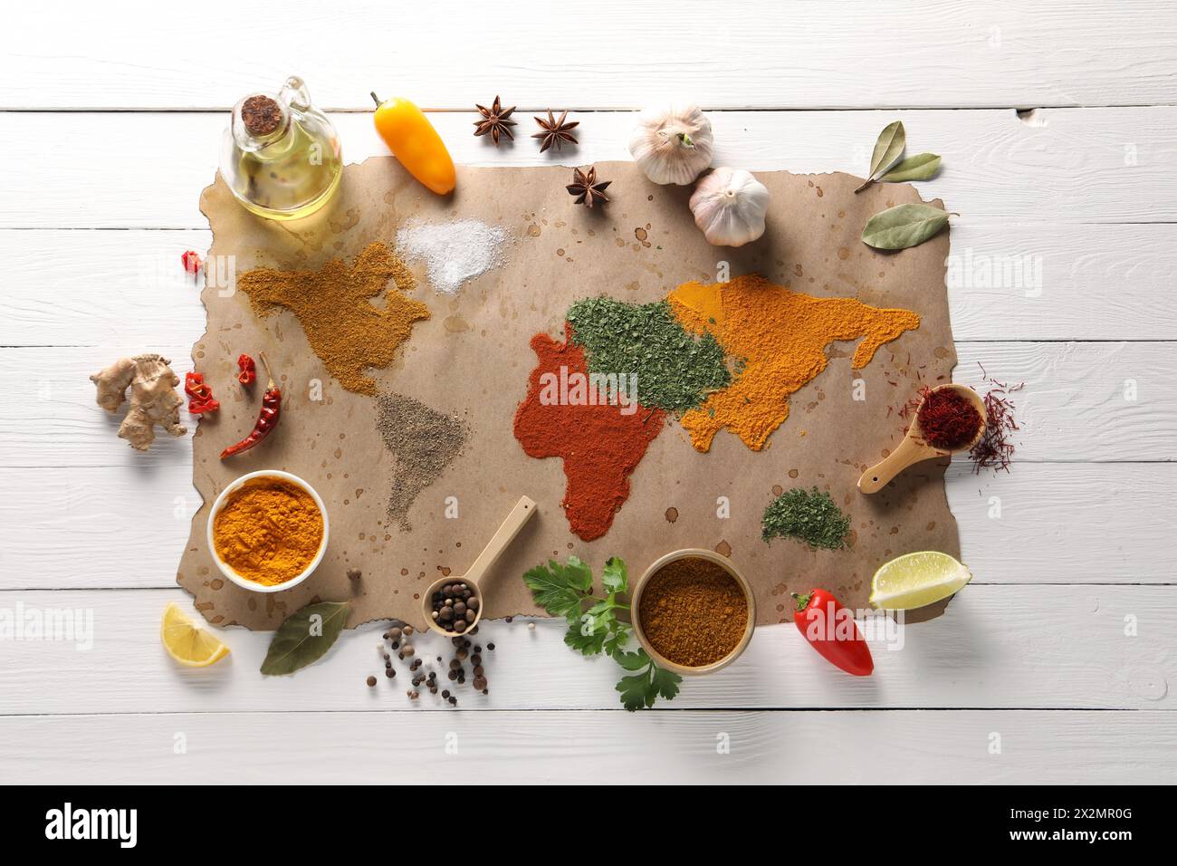 World map of different spices and products on white wooden table, top ...