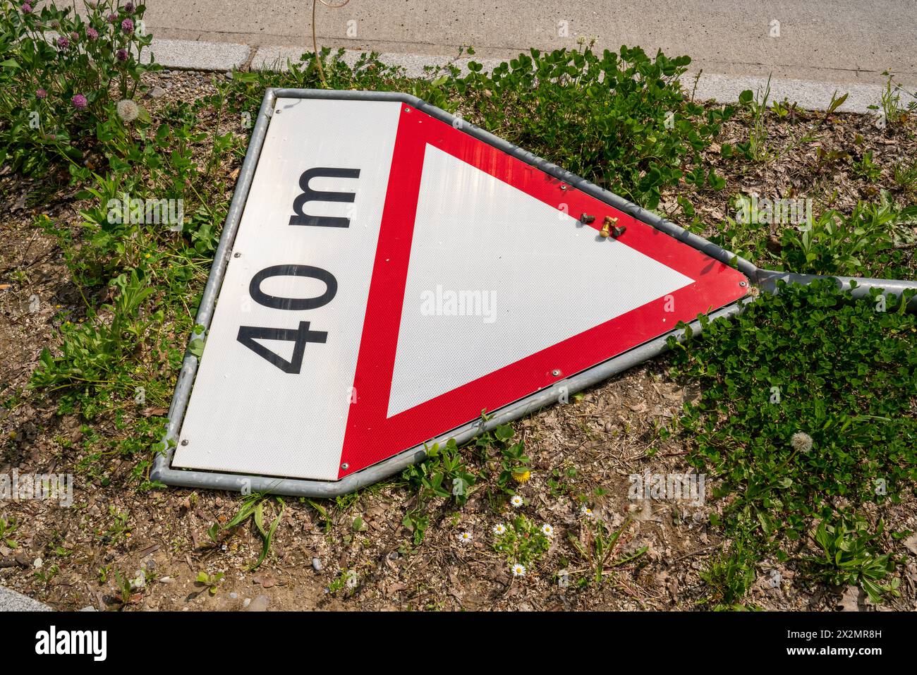 Road sign lying on the ground on a refuge island, that is still a ...