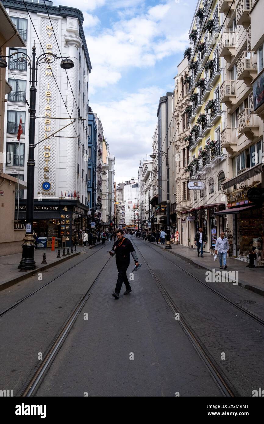 Street scene with passers-by, shops and apartment blocks in Istanbul ...