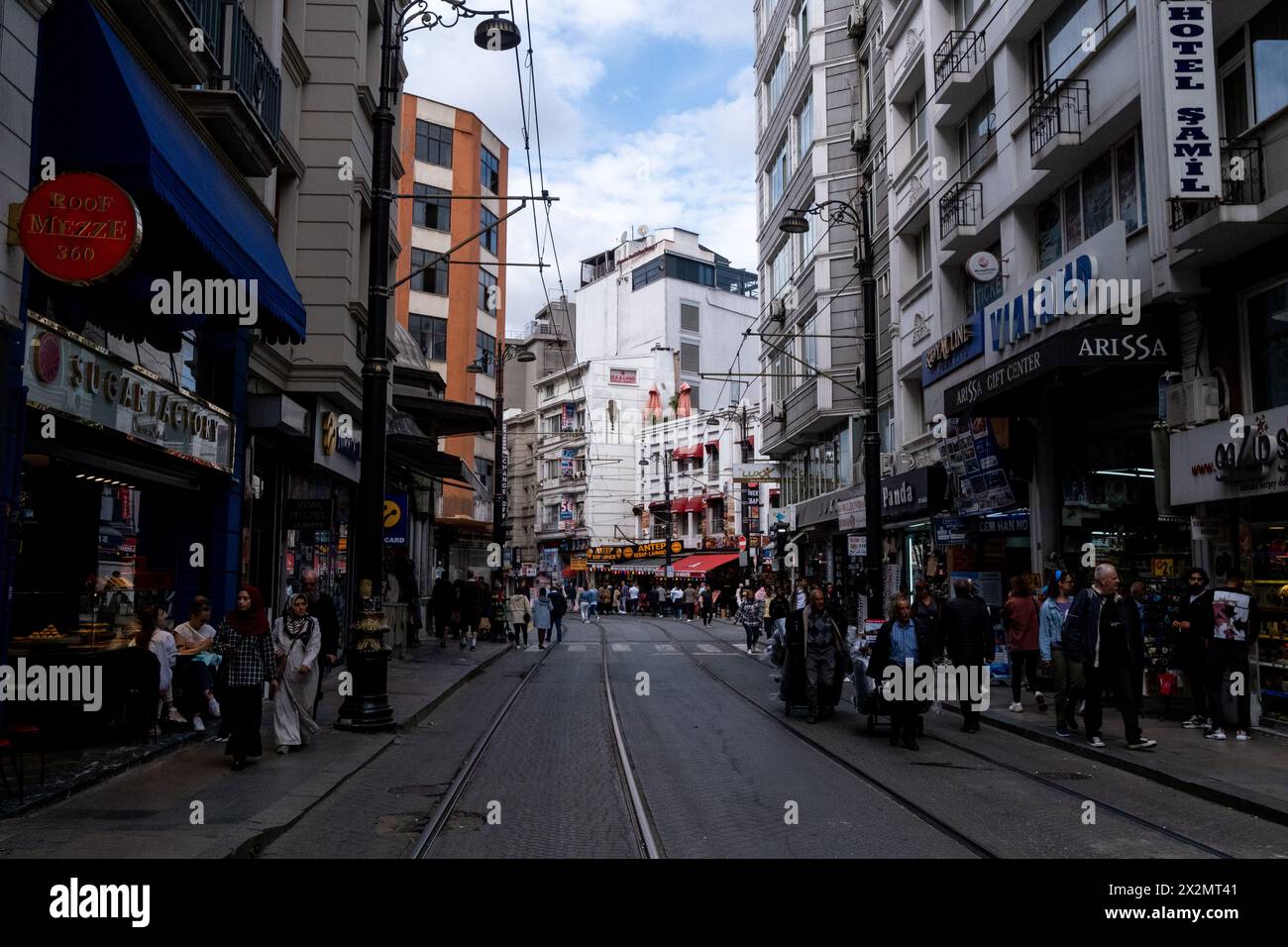 Street scene with passers-by, shops and apartment blocks in Istanbul ...