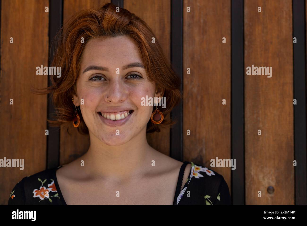 Portrait of young woman (22) Latin American redhead with smiling face ...