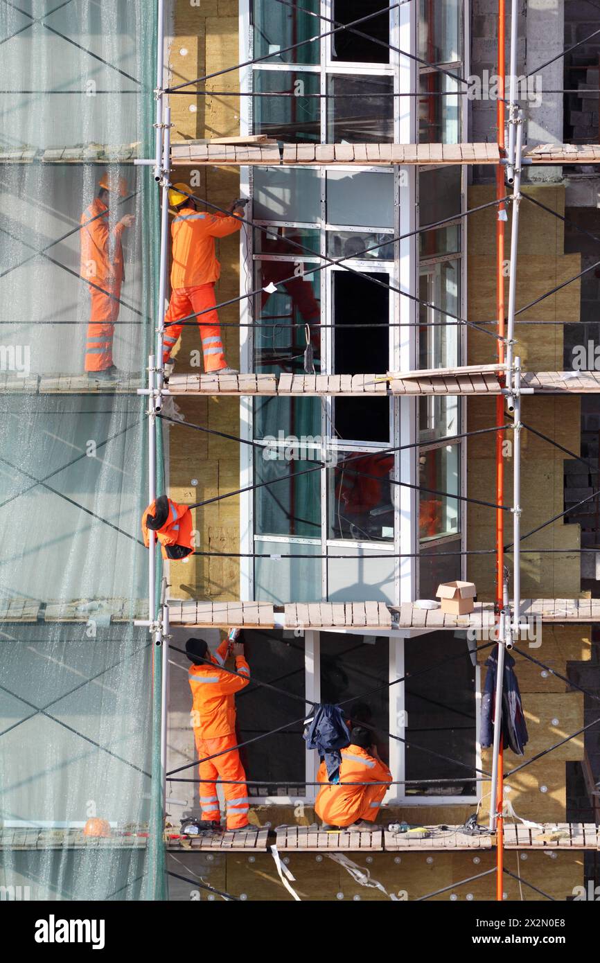 MOSCOW - OCTOBER 7: Men works on scaffolding of buildings of complex ...