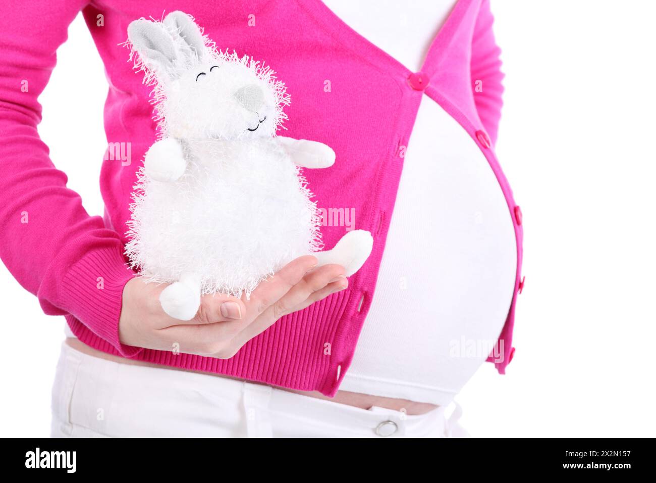 Belly of pregnant woman holding white toy rabbit with unreal design ...