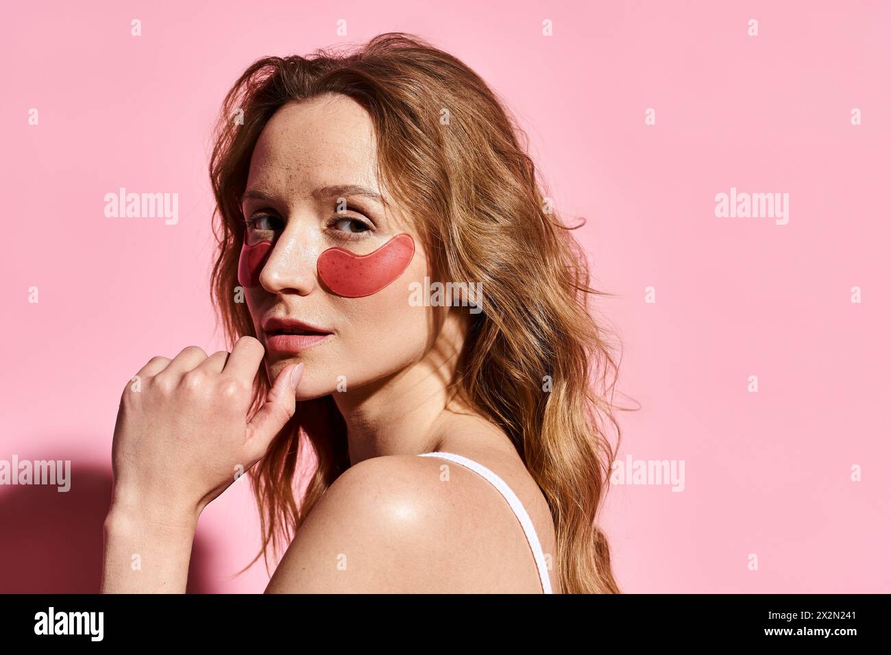 A stunning woman with eye patches on her cheek poses gracefully ...