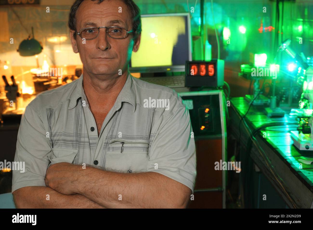 Scientist with glass pose in his lab of movement of microparticles by ...