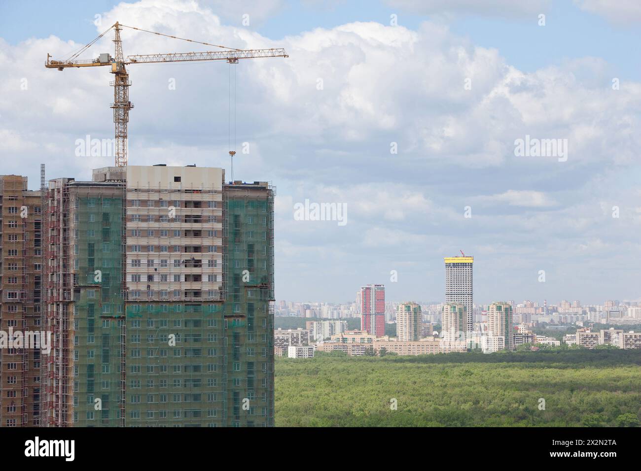 Construction of new high buildings with green building grid Stock Photo ...