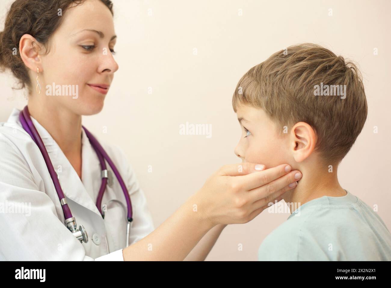 Doctor checks little boy lymph nodes, focus on boy Stock Photo - Alamy