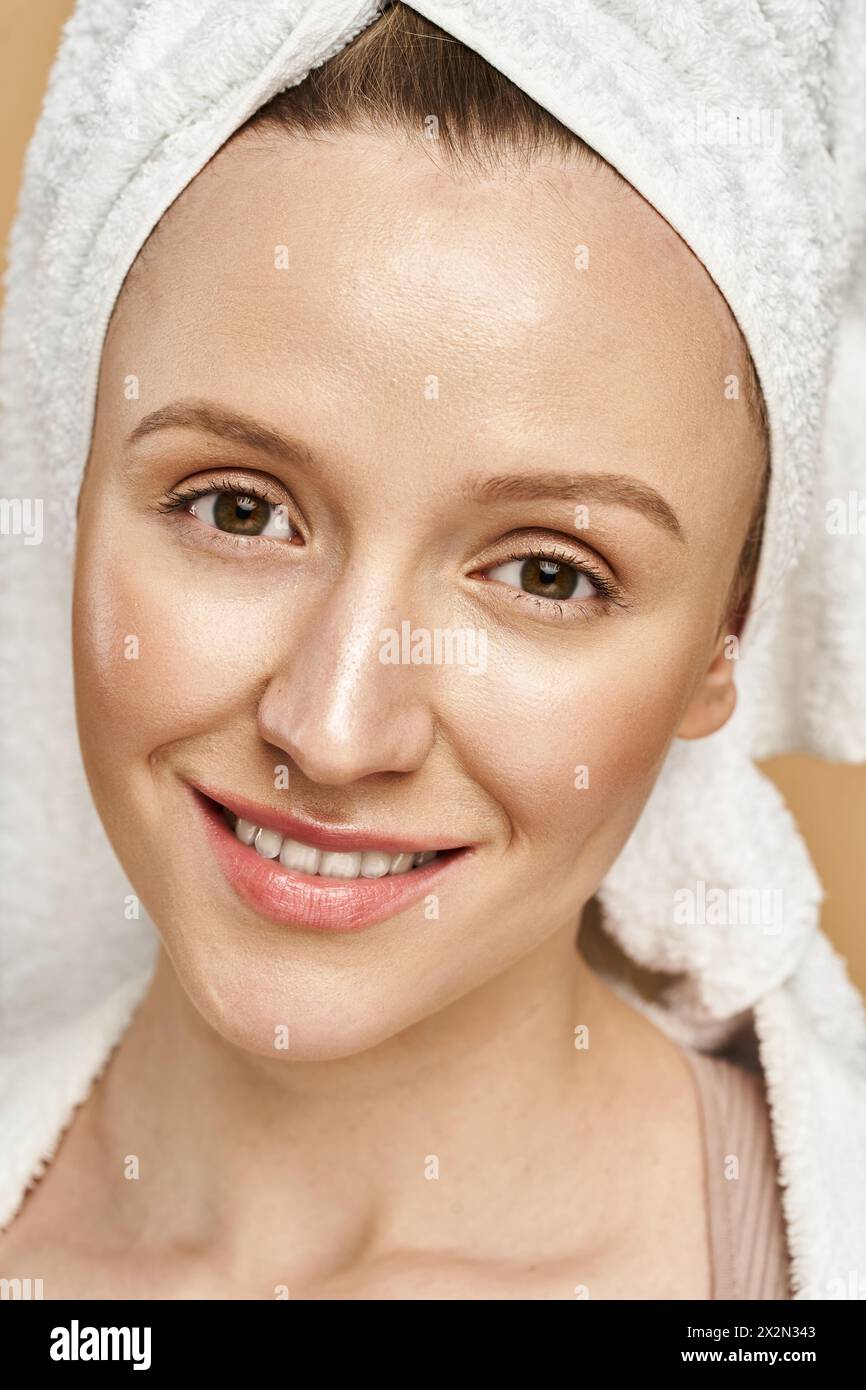 A stunning woman with natural beauty gracefully poses with a towel ...