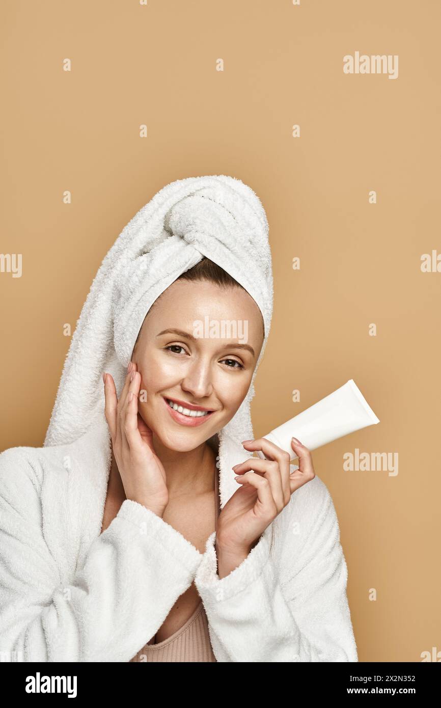 A stunning, natural beauty poses with a towel draped elegantly over her ...