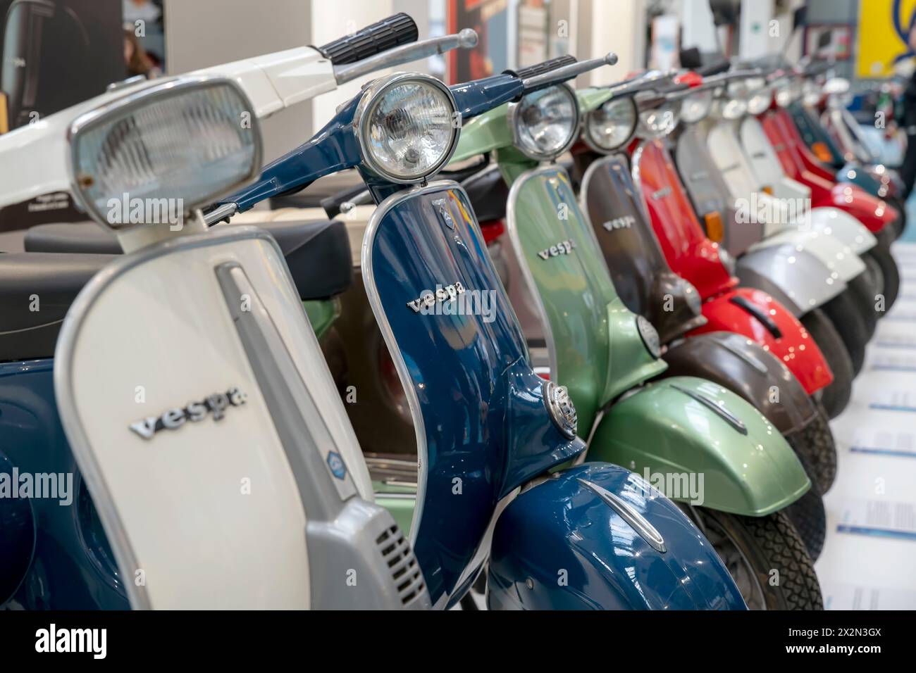 Numerous and colorful Vespas are lined up on display at the Piaggio ...