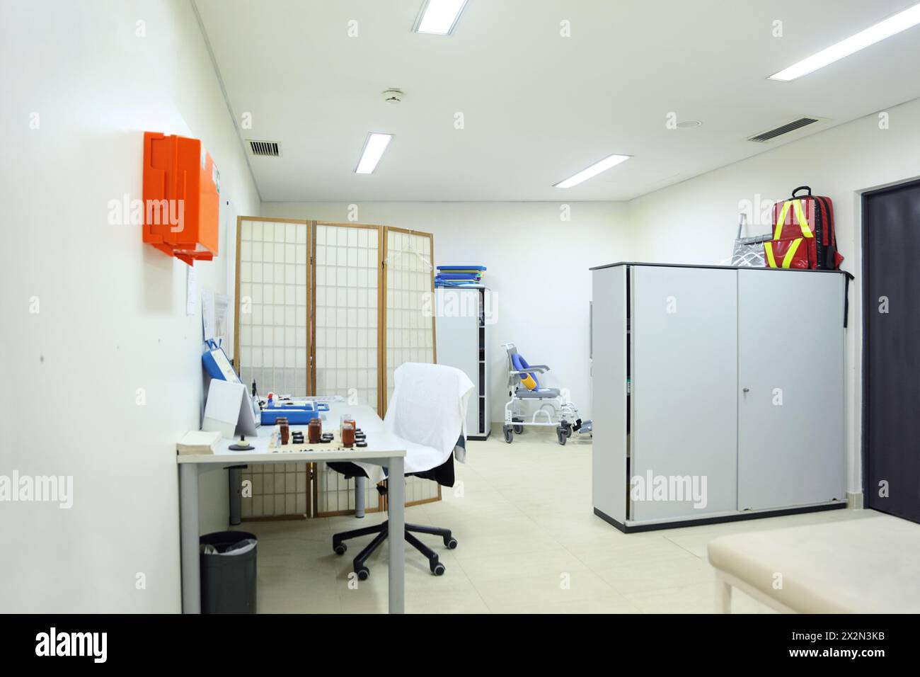 Empty light room first aid. Table with medicines and wheelchair Stock ...