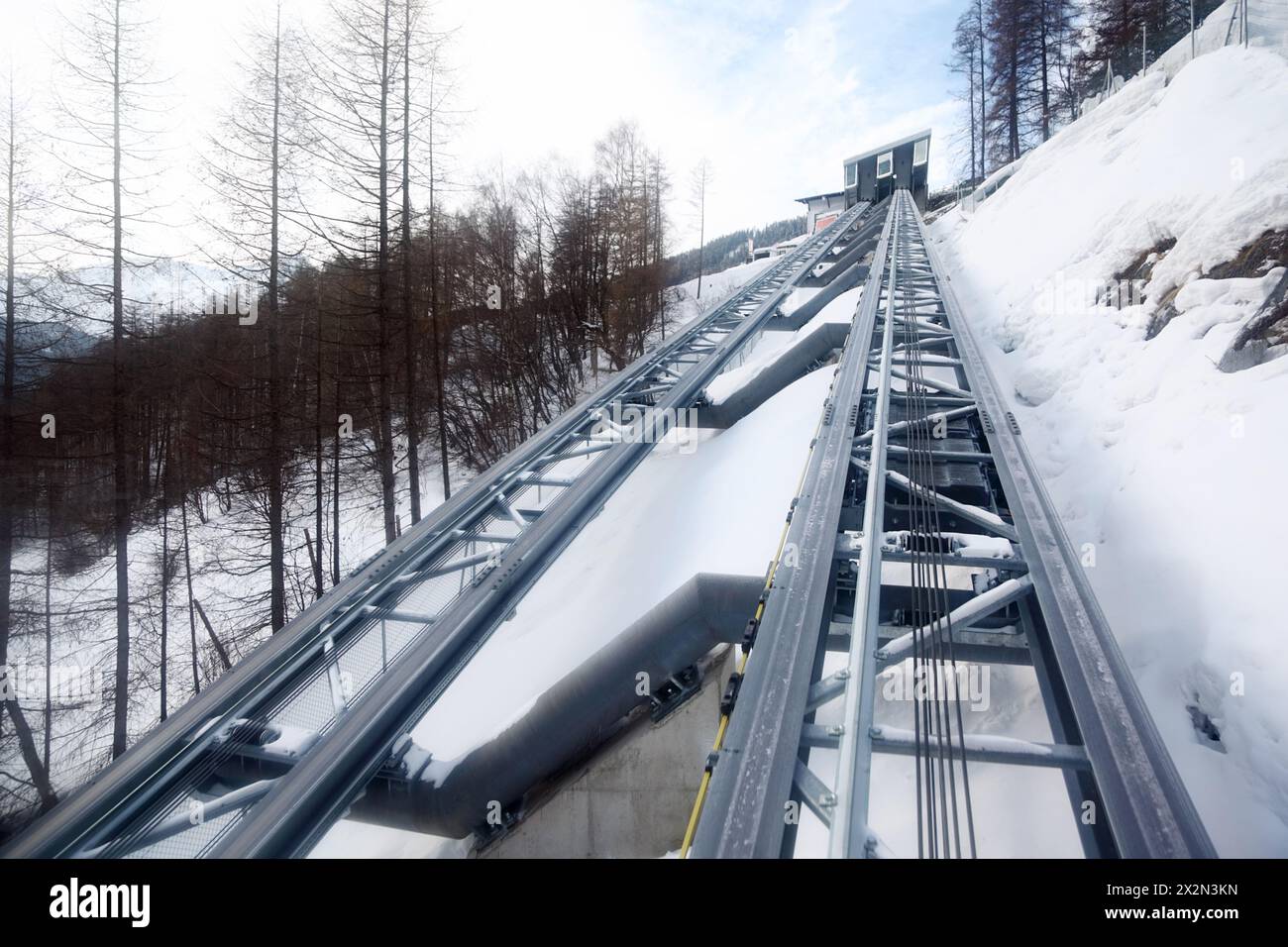 Metal tracks for mountain lift and winter forest in mountain Stock ...