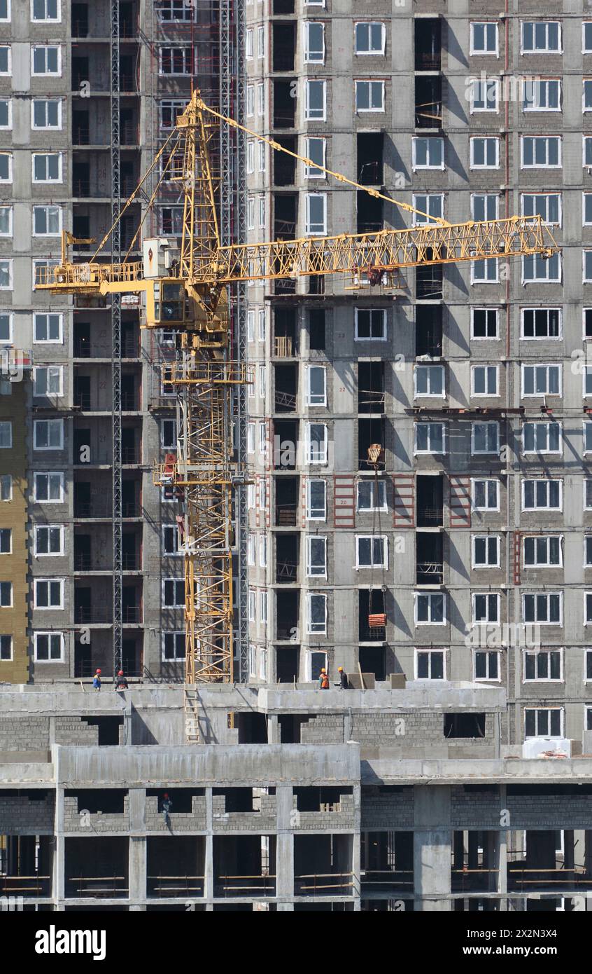 Construction of new building with crane, focus on crane Stock Photo - Alamy