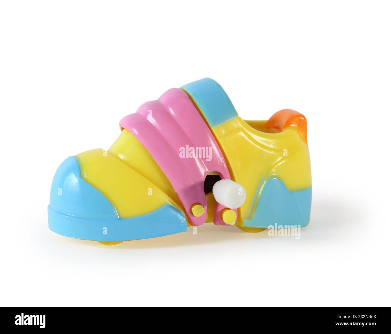 Colorful plastic toy mechanical sneaker isolated on white background ...