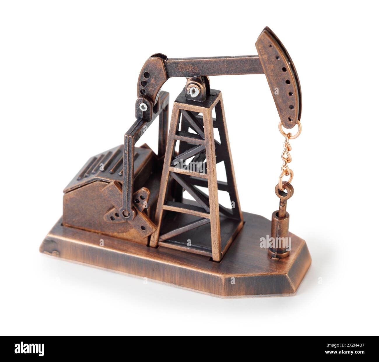 Metal mechanical miniature model of oil derrick isolated on white ...