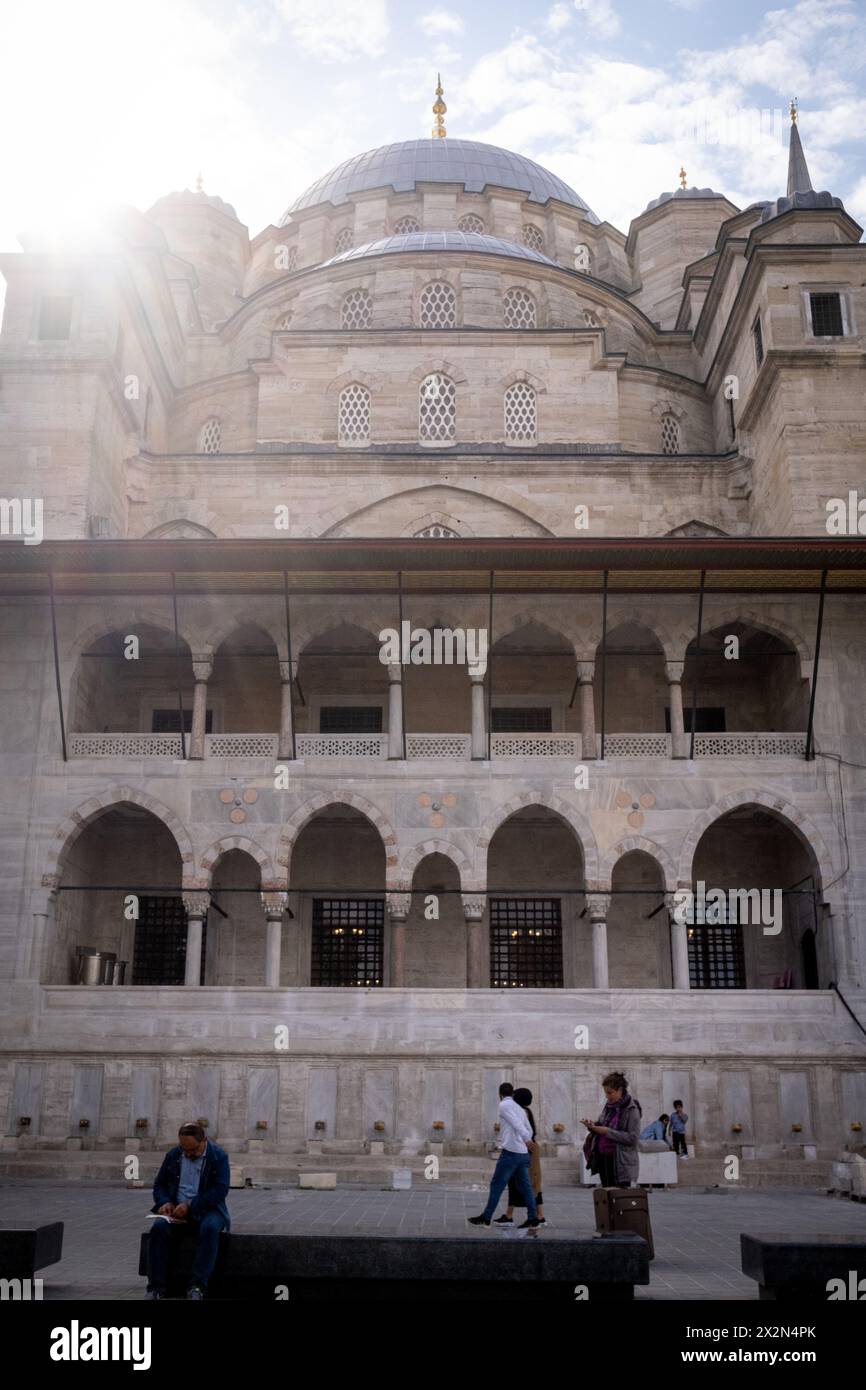 Backlit view of passers-by and tourists in the sunlight near the New ...