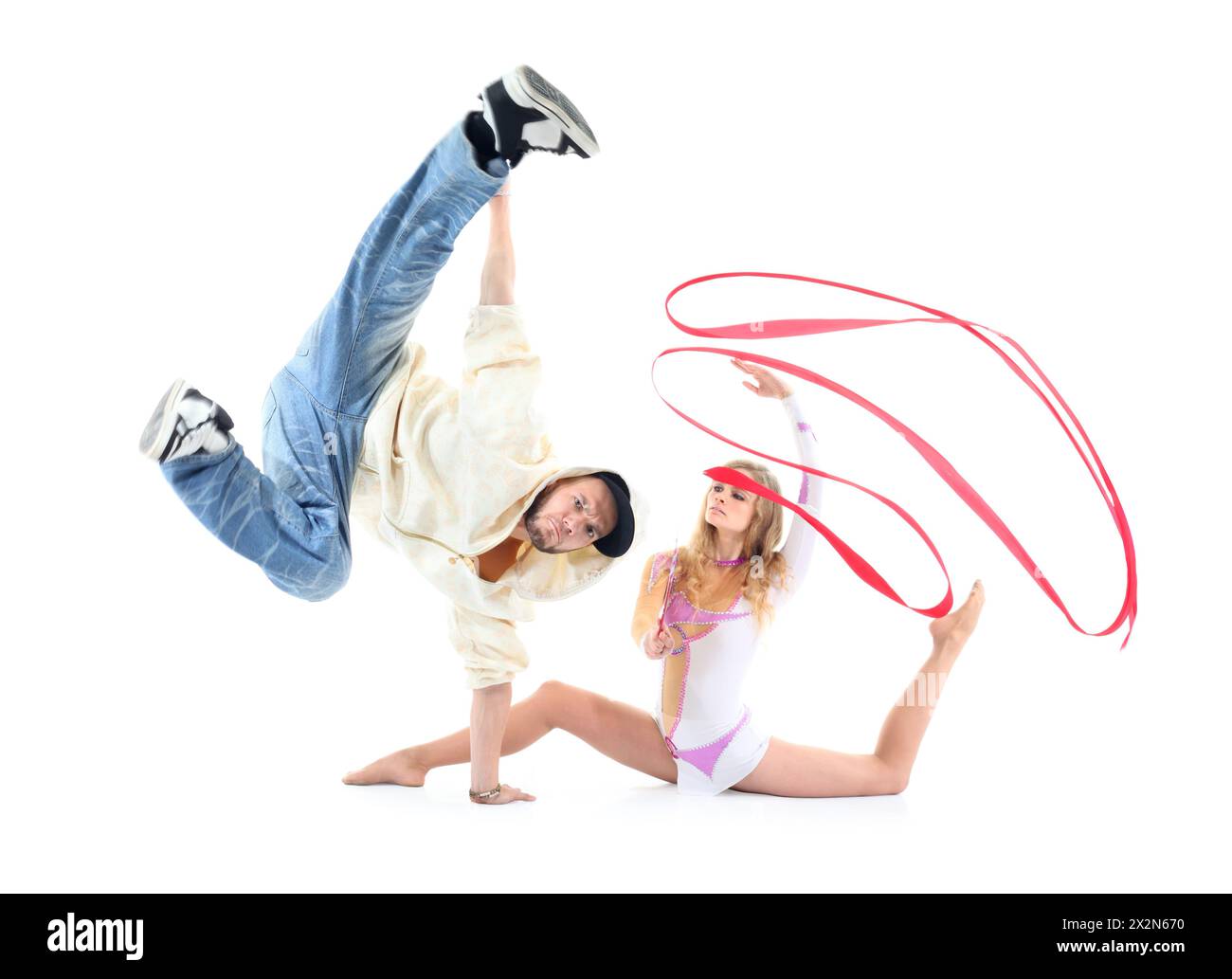 Young breakdancer stands on one hand and leg held up and graceful ...