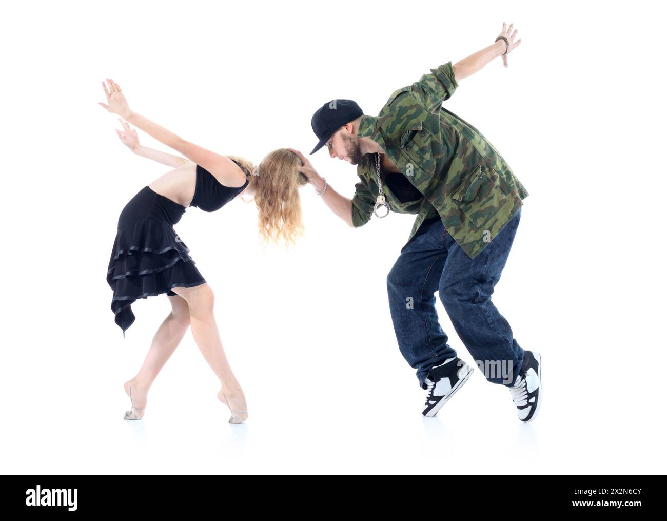Gymnast and rapper stand on tiptoe, arms tossed back isolated on white ...