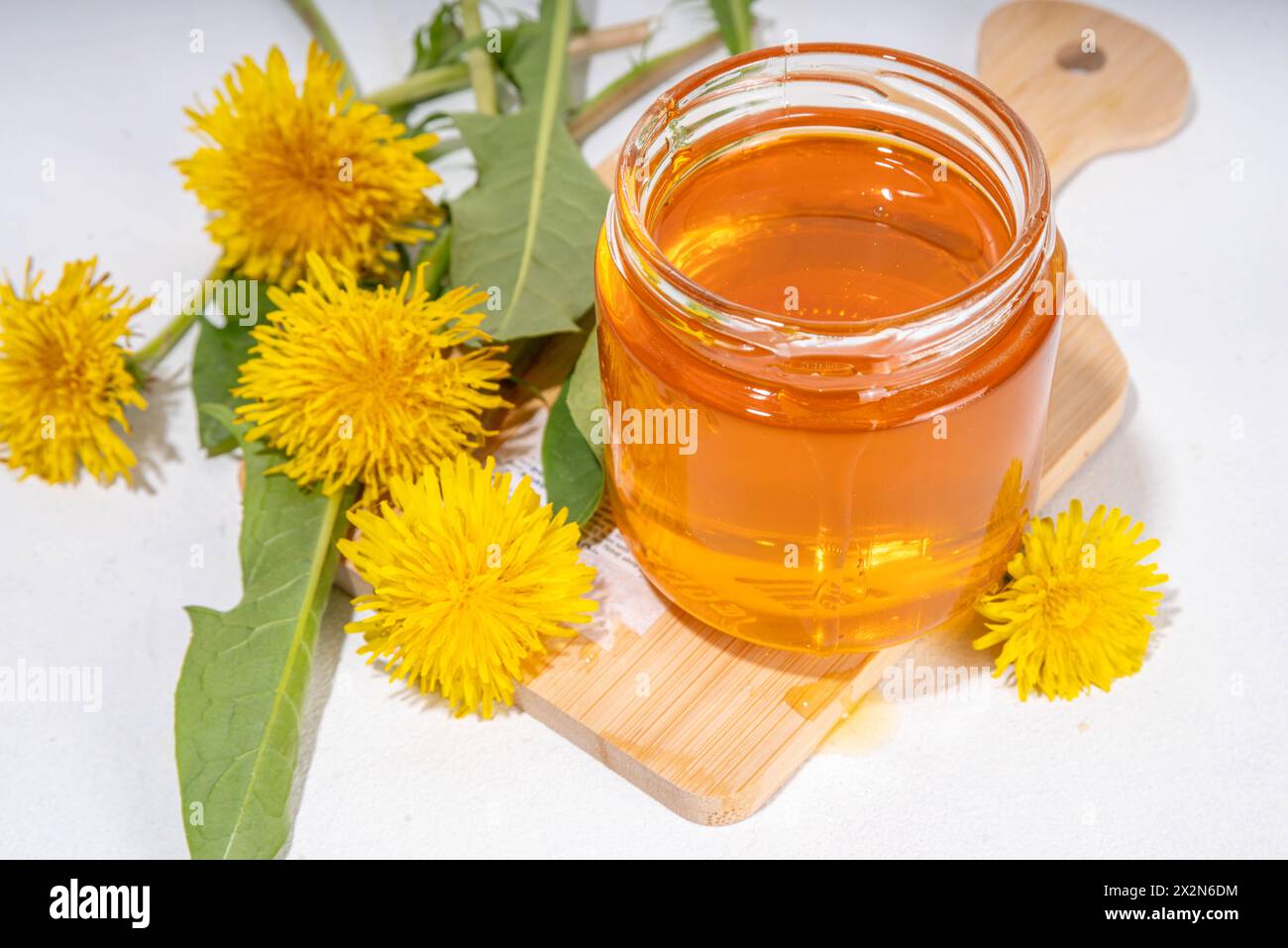 Dandelion jam, jelly confiture in a jar with fresh dandelion flowers on ...