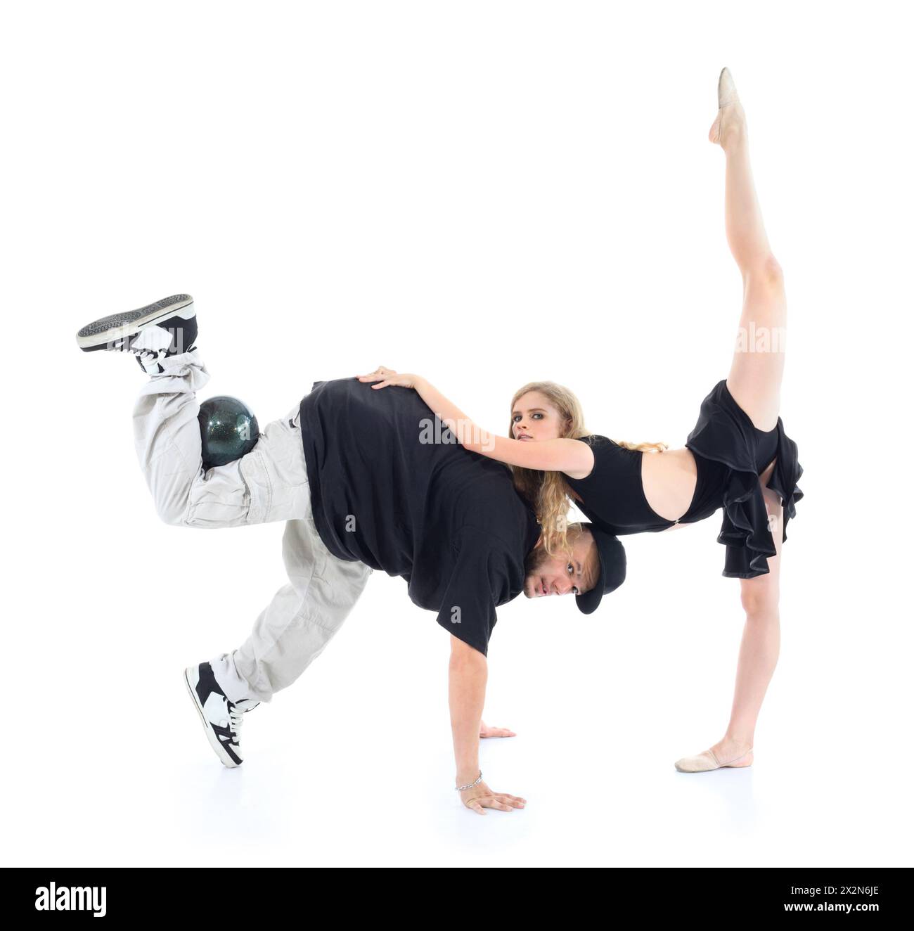 Gymnast stands on one leg, other leg lifted up and rests hands on man ...