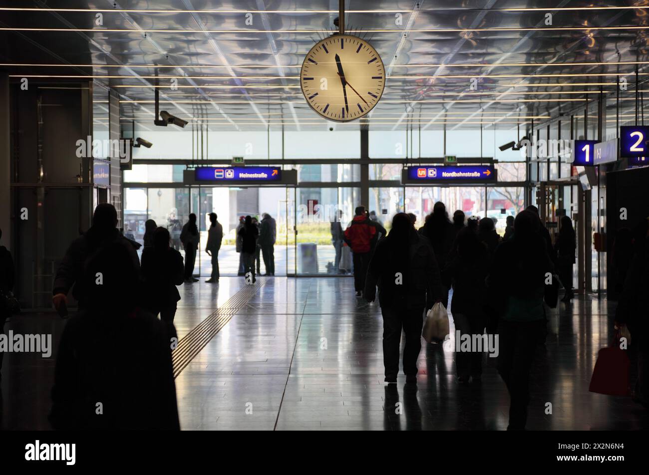 Railroad station with clock, people in Vienna, Austria, focus on clock ...