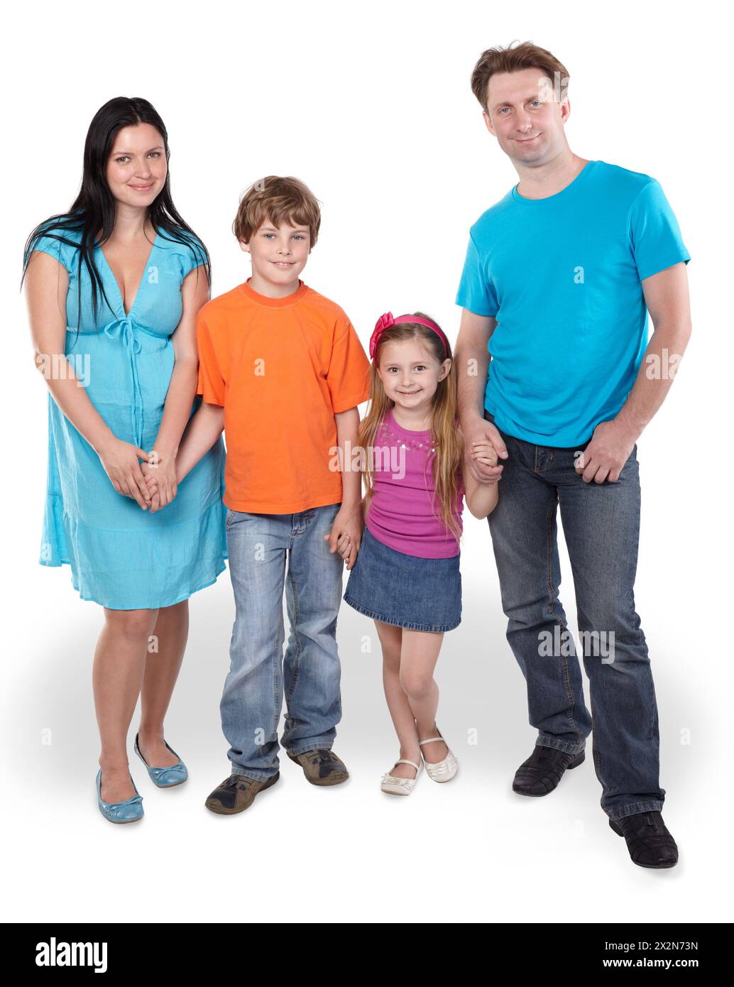 Smiling family of four stands together holding hands Stock Photo - Alamy