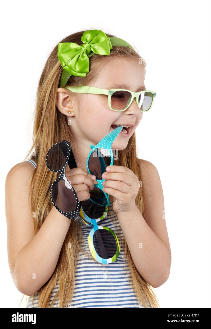 Little girl in striped sundress and green band in hair with several ...