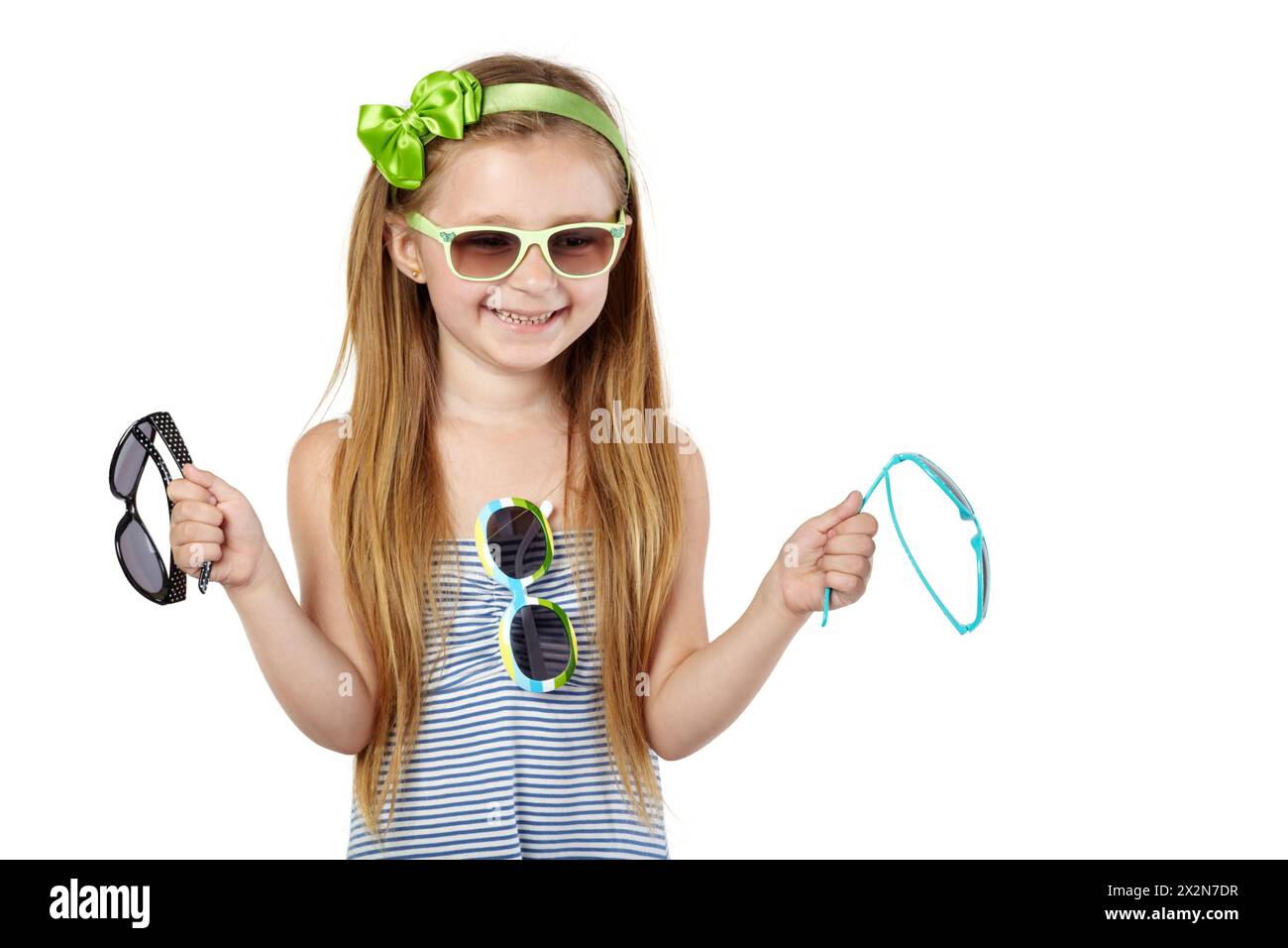 Little girl in striped sundress and green band in hair with four ...