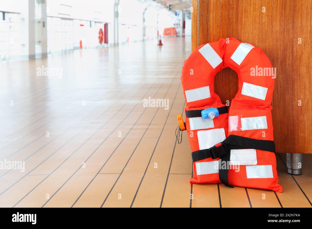 Singular orange life jacket stands on deck of cruise passenger liner ...