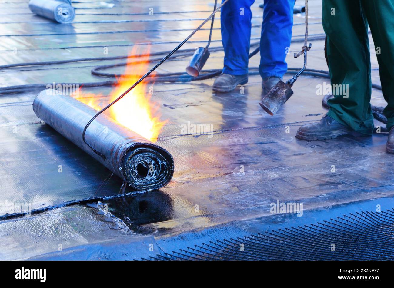 men Crout roof with hot tar Stock Photo - Alamy