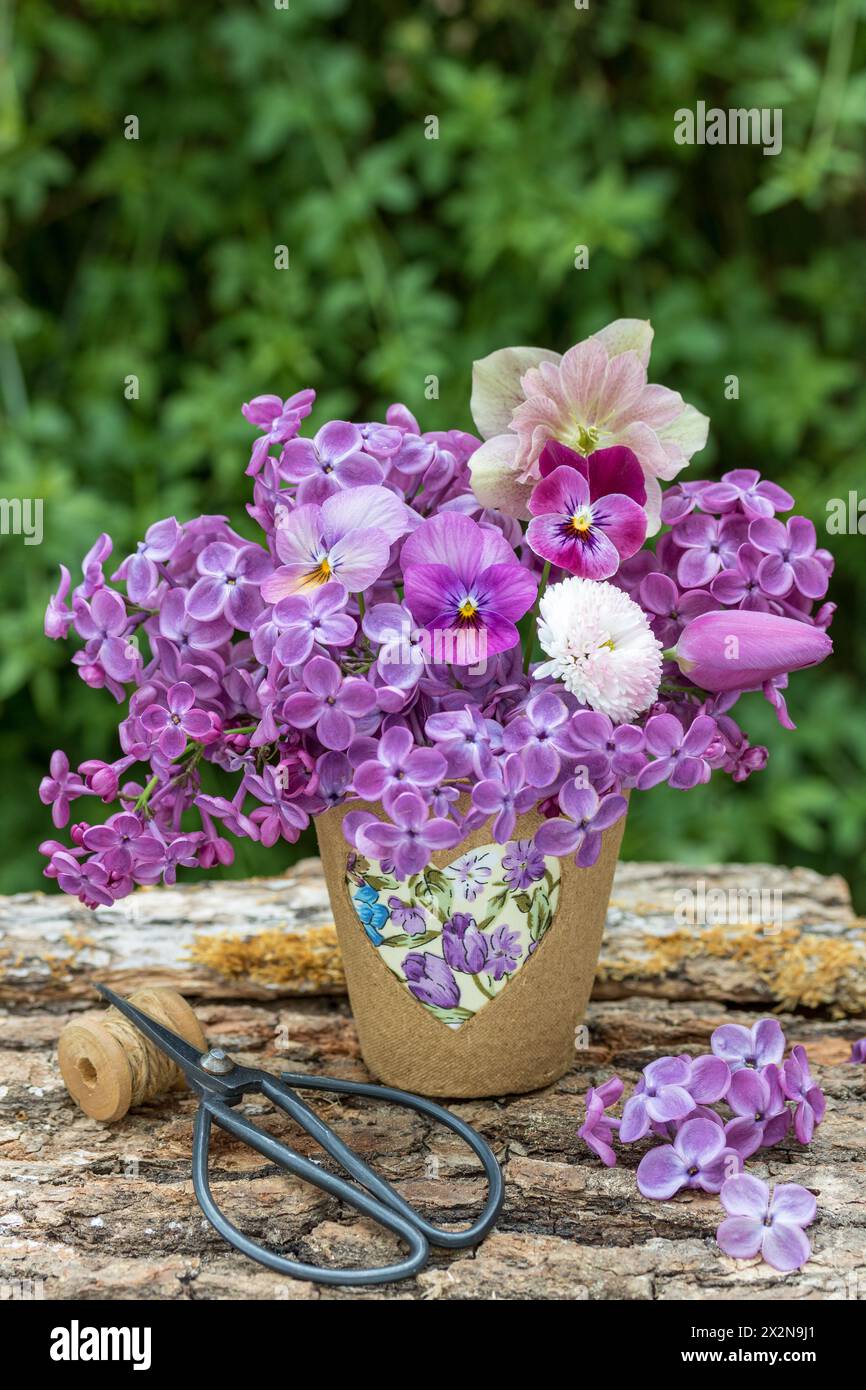 romantic bouquet of lilac, viola flowers, lenten roses, tulip and ...