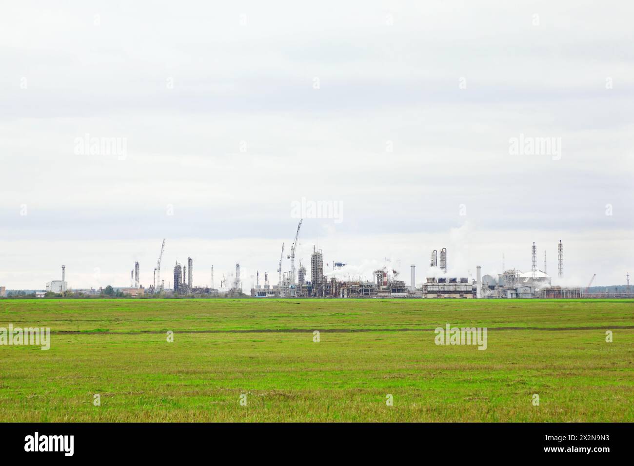 Industrial zone with factories and pipes with smoke. Green field Stock ...