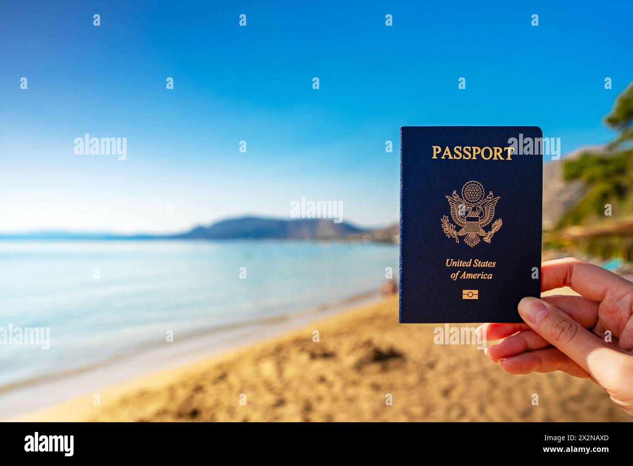 Man holding USA passport against the backdrop of a tropical country ...