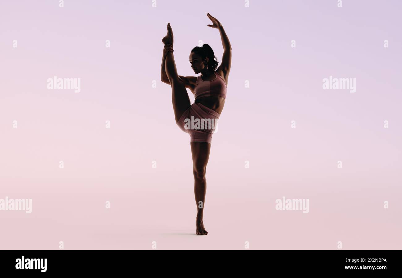 Female gymnast displaying her agility and flexibility in a studio ... Female gymnast displaying her agility and flexibility in a studio ...