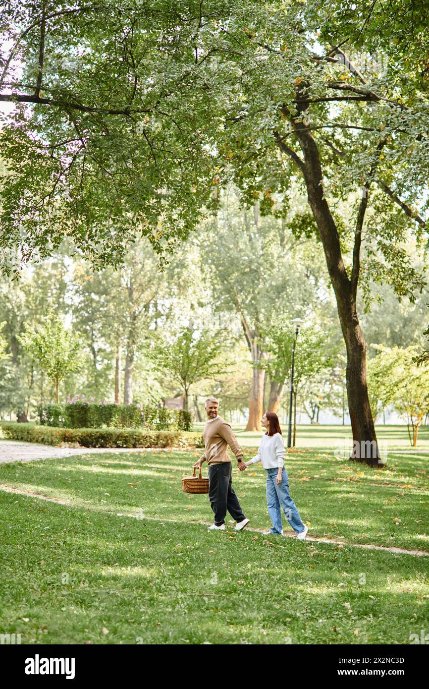 A loving couple, casually dressed, walks through a peaceful park Stock ...