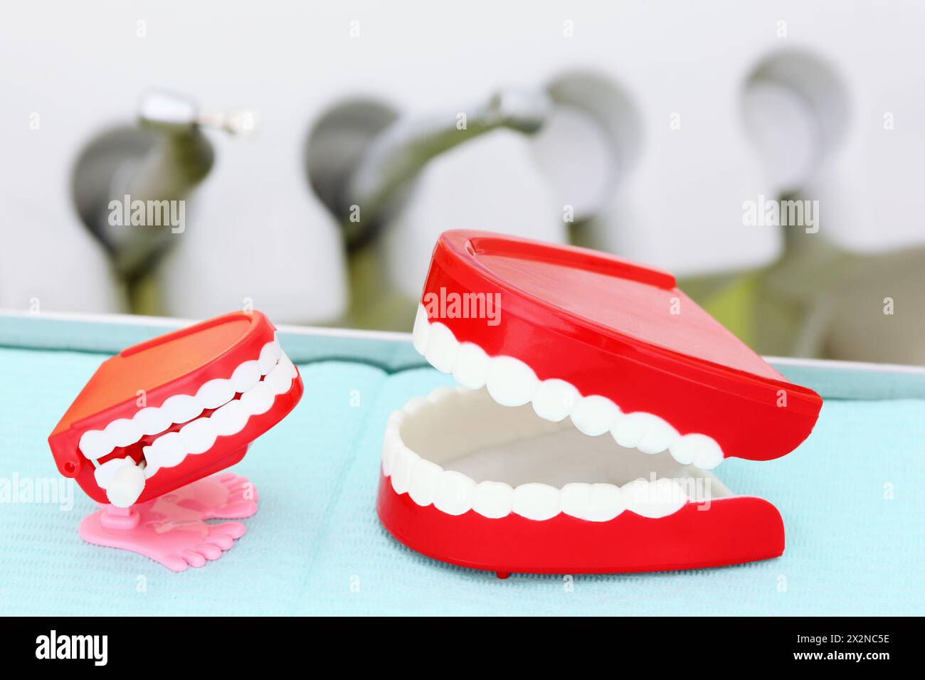 Two toy mechanical jaws are on table at background of dental ...