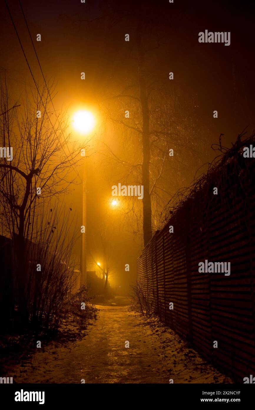 The dark alley between the fences at night Stock Photo - Alamy